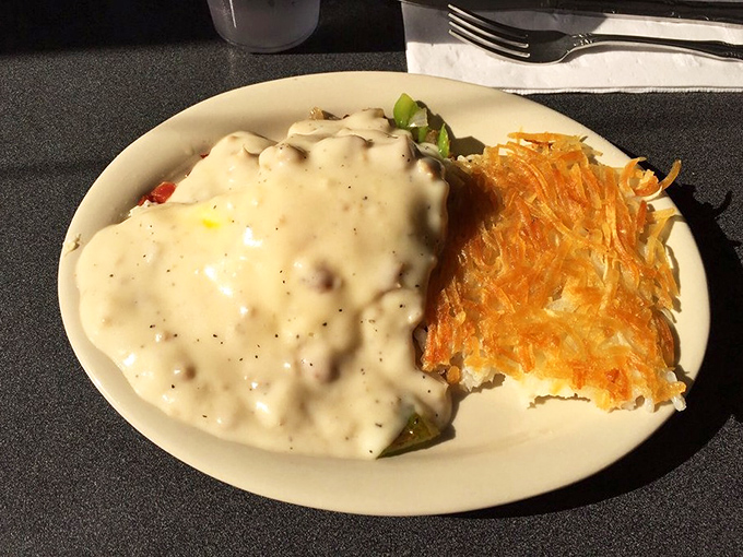 Country gravy cascading over fresh biscuits with the golden crown of hash browns&mdash;breakfast that fuels a day of adventure.