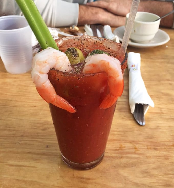 This Bloody Mary isn't just a drink; it's breakfast, appetizer, and cocktail in one glass. Those prawns are basically saying "come on in, the tomato's fine!"
