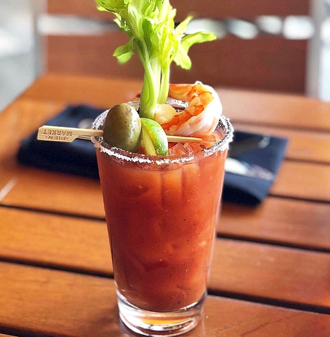 This Bloody Mary isn't just a drink, it's a seafood appetizer in disguise, complete with a prawn that's taking a spicy bath.