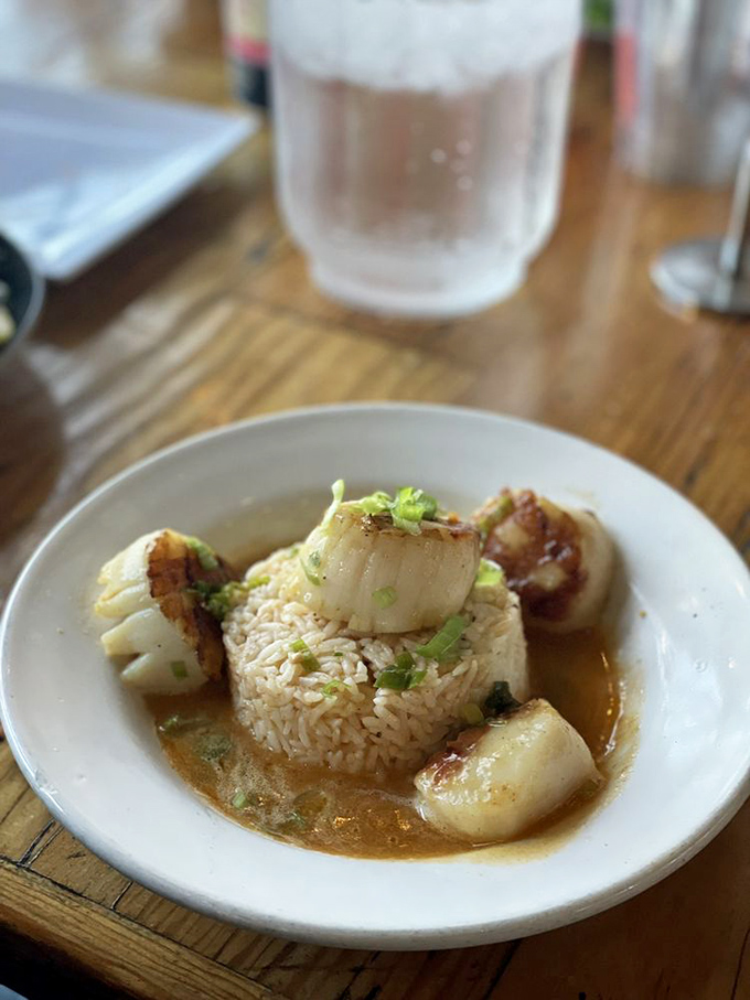 Bourbon butter scallops surrounding a throne of rice&mdash;fit for seafood royalty. These caramelized beauties deliver that perfect sweet-savory balance that makes taste buds stand at attention.