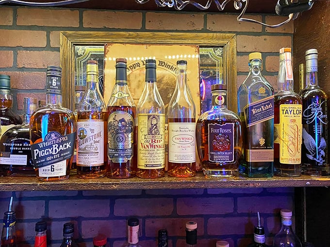 The bourbon selection speaks to a bar that knows priorities. No fancy backlit shelves needed when the amber liquid does all the talking.