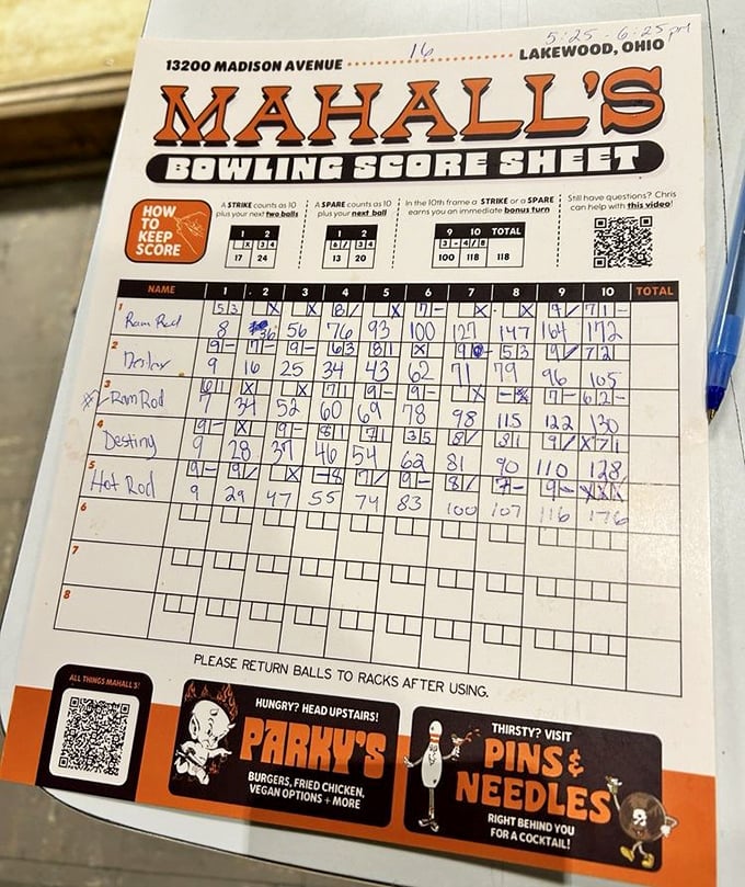 The sacred scoresheet—where mathematical miracles happen and friendly rivalries are documented in blue ink for posterity. Parky's burgers and Pins & Needles cocktails await below.
