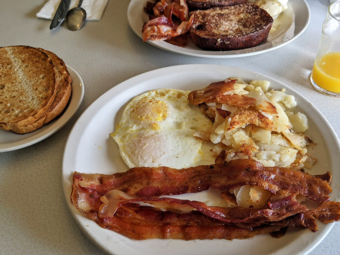 The breakfast trinity: perfectly cooked eggs, bacon with the ideal crisp-to-chew ratio, and home fries that didn't come from a freezer bag.