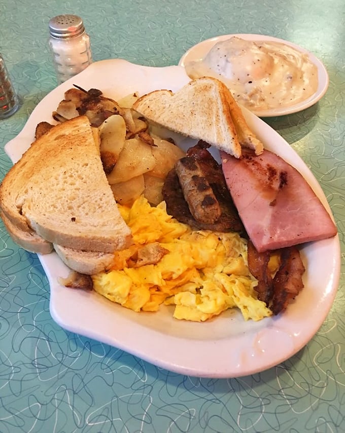 The breakfast plate that answers the eternal question: "Why choose between eggs, meat, potatoes, and toast?" Pure morning bliss on a plate.