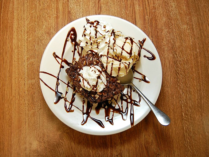 A brownie dessert drizzled with chocolate and topped with ice cream &ndash; proof that sometimes the simplest pleasures are the most profound.