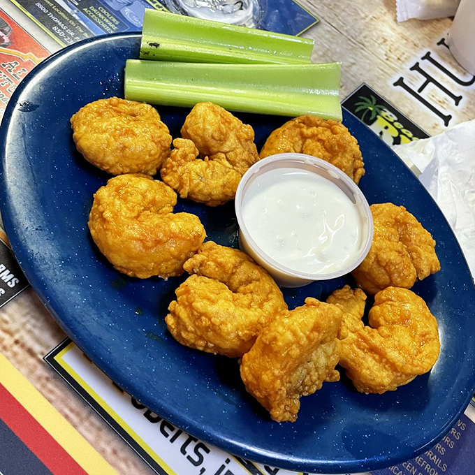 Buffalo shrimp that pack enough heat to make you reach for your drink and smile simultaneously.