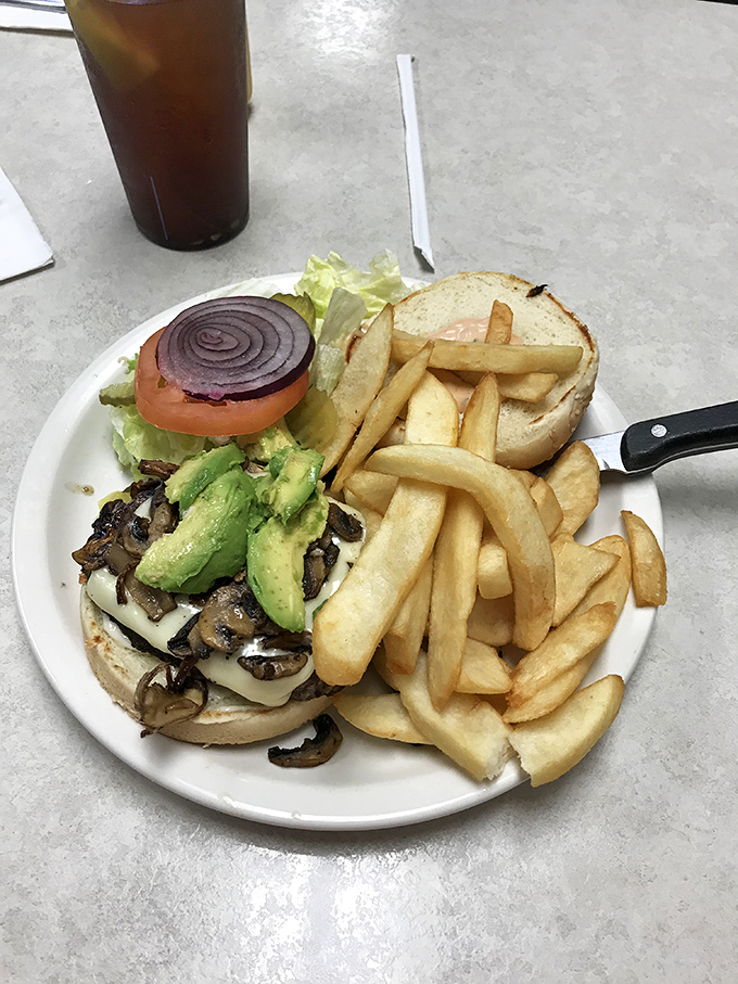 This isn't just a burger&mdash;it's an architectural marvel of mushrooms, avocado, and melted cheese that requires both hands and zero distractions.