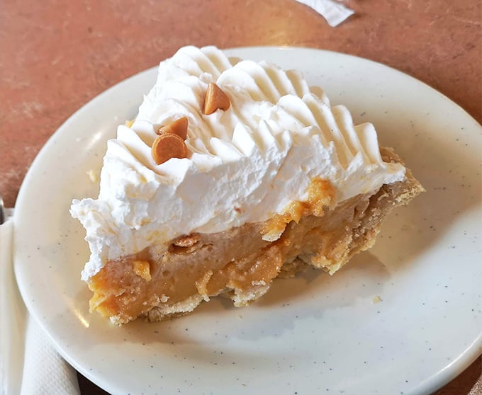 Butterscotch pie crowned with a cloud of whipped cream&mdash;the kind of dessert that makes you seriously consider ordering a second slice before finishing the first.