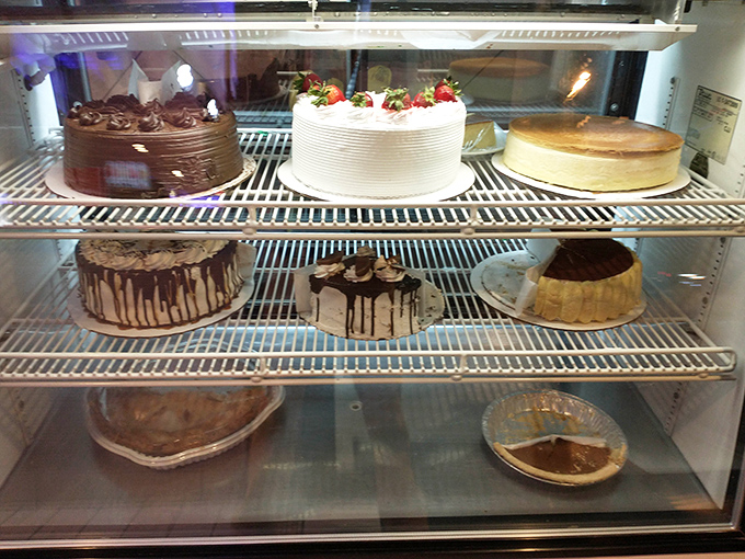The dessert case – where willpower goes to die and "I'll just have coffee" turns into "and a slice of that chocolate cake, please."