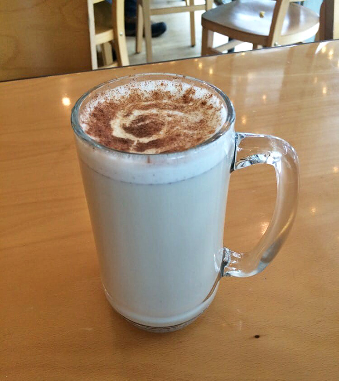 A frothy chai latte provides the perfect counterpoint to sweet pastries. The mug size suggests they understand the seriousness of proper caffeine delivery.