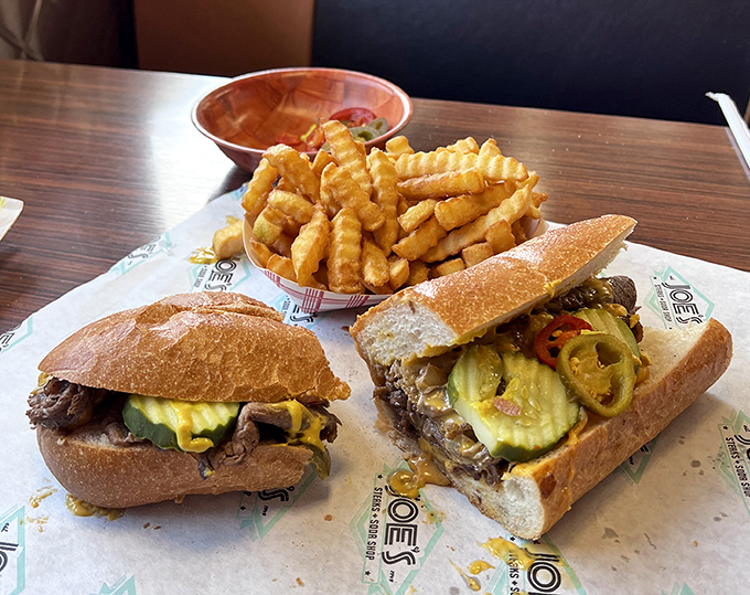 Two cheesesteaks having a serious conversation with a basket of fries&mdash;the kind of meeting you definitely want to crash.
