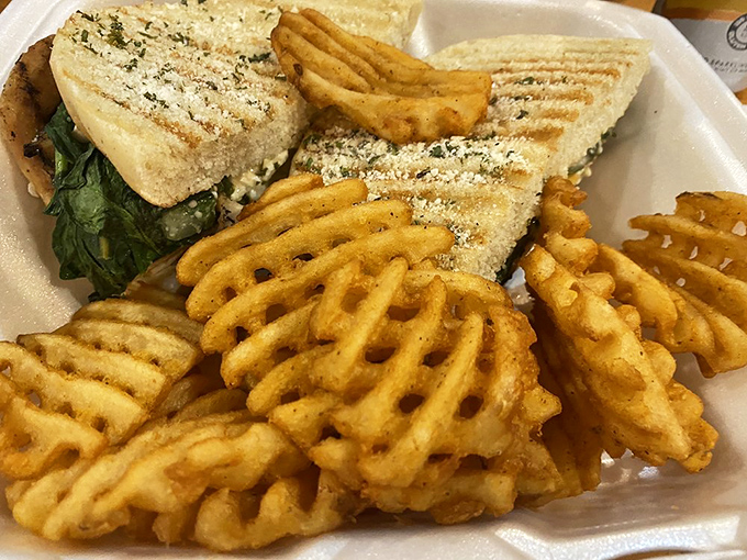Waffle fries and a sandwich that requires both hands and several napkins&mdash;the universal language of "worth the mess." 