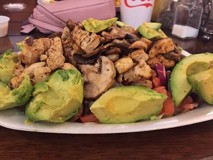 A salad so generous and colorful it almost makes you forget you came for the burgers. Almost. Those avocado chunks are practically showing off.