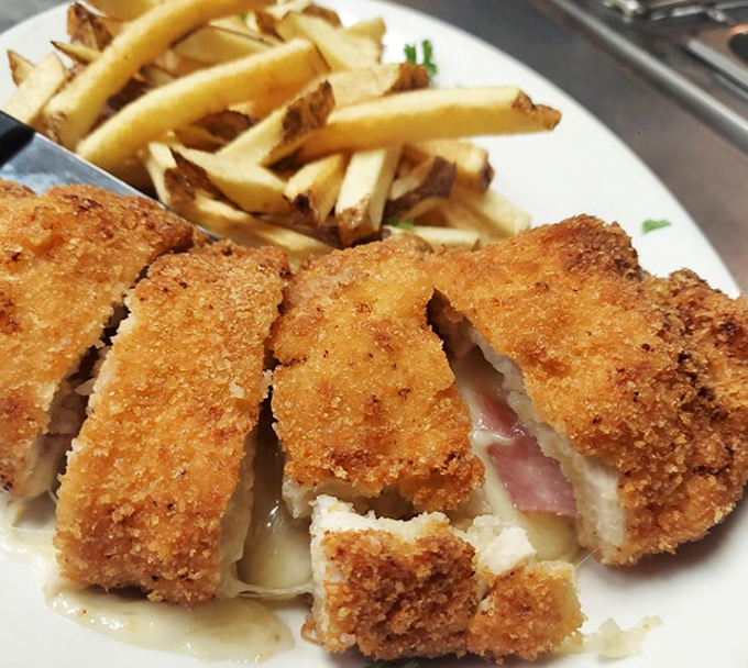 Golden-fried chicken cordon bleu with crispy fries&mdash;proof that sometimes the best things in life involve breading, cheese, and a deep fryer.