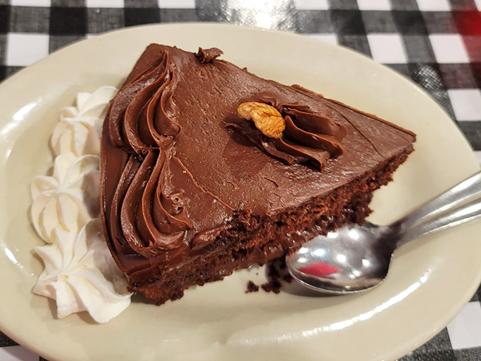 A slice of chocolate cake so rich and decadent it should come with its own warning label and possibly a small loan.