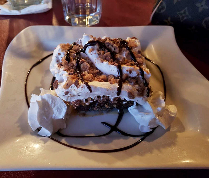 This isn't just chocolate cake&mdash;it's a towering monument to indulgence with whipped cream and chocolate drizzle for good measure.