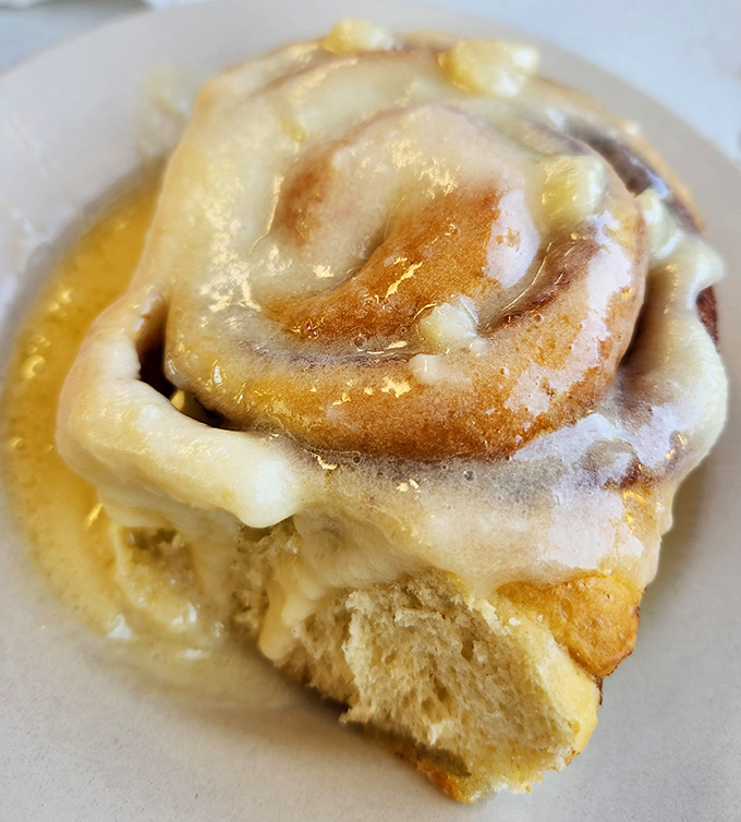 This cinnamon roll isn't just breakfast&mdash;it's dessert with a permission slip. The icing pools like a sweet lagoon you'll want to swim in.
