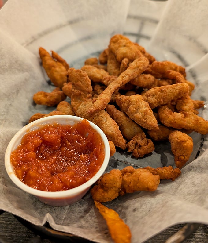 These golden-fried clam strips aren't just appetizers&mdash;they're little crunchy vessels of oceanic happiness, perfect for dipping and sharing.