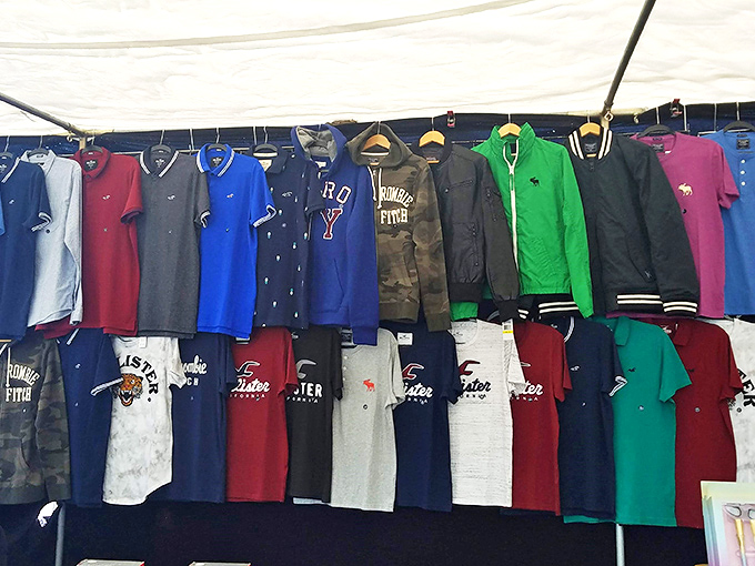 Clothing vendors transform simple racks into boutique experiences. That green jacket is practically screaming to become the star of your next casual Friday.