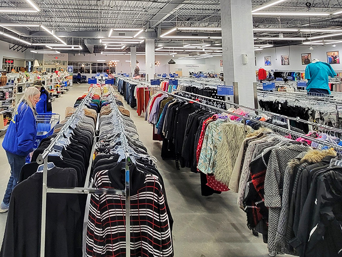 Clothing racks stretch endlessly, proving that one person's closet purge becomes another's fashion goldmine discovery.