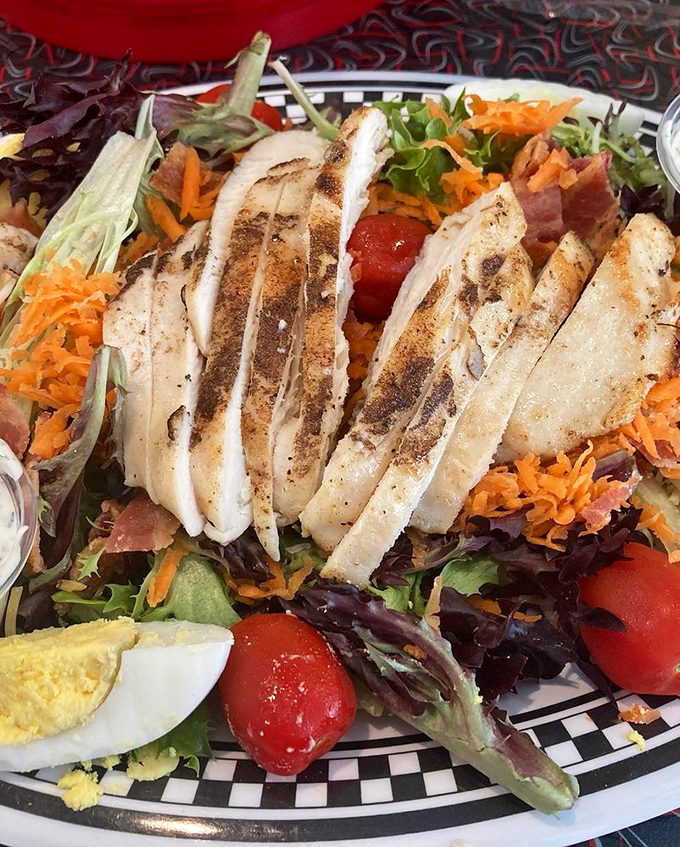 This isn't just a cobb salad&mdash;it's a colorful landscape of grilled chicken, fresh vegetables, and possibility, all on a checkered-rim plate.