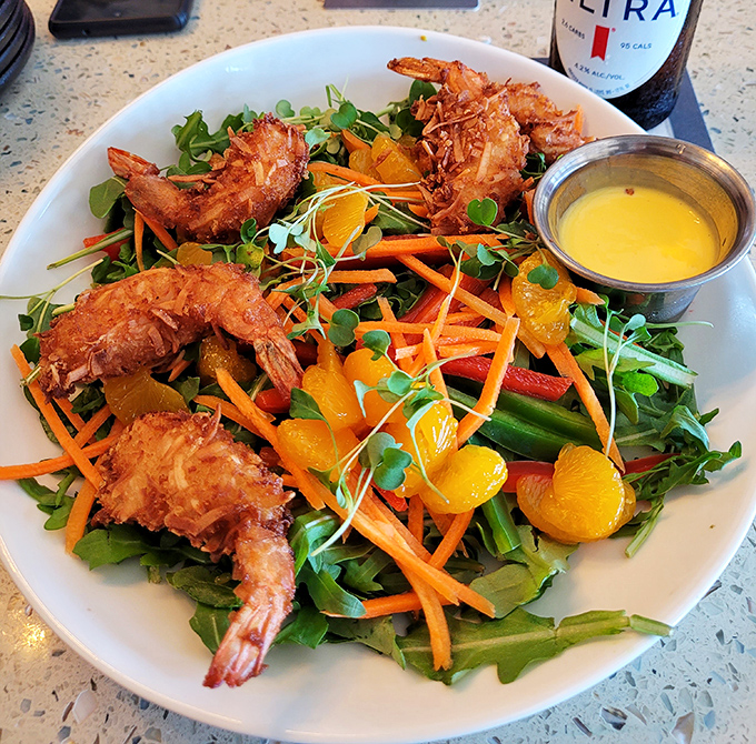 Coconut shrimp perched atop a garden of greens. When salad feels like a celebration, not an obligation.