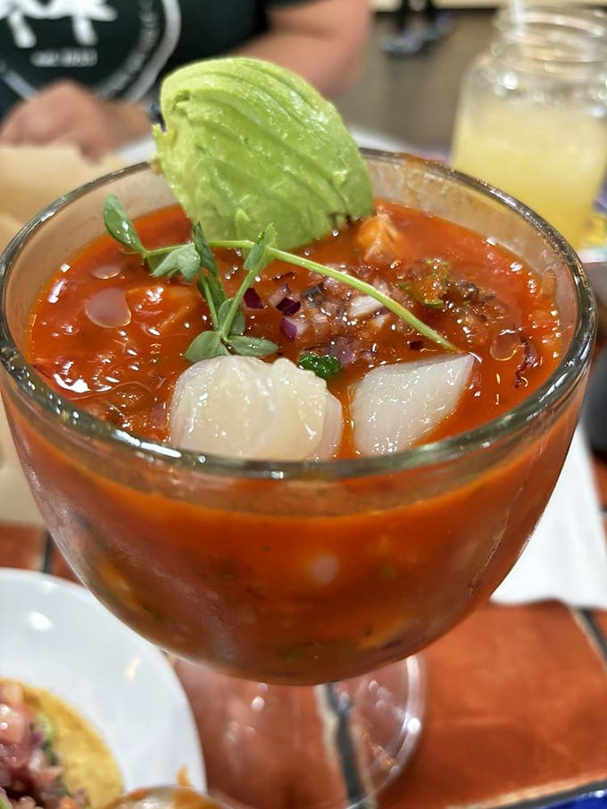 A cocktail glass brimming with tomato-bathed seafood treasures&mdash;like a tiny ocean you can eat with a spoon.