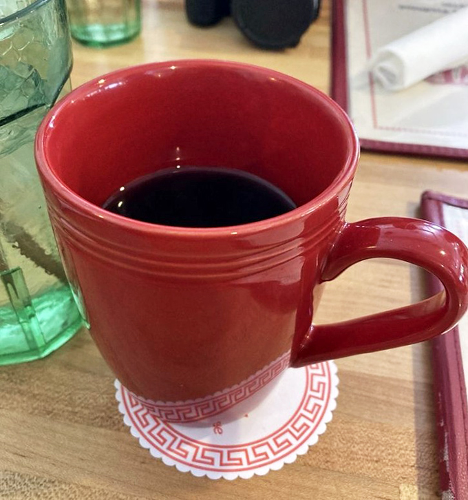 The humble red coffee mug&mdash;keeper of the elixir that powers mountain adventures. Bottomless refills here aren't just courtesy; they're practically law.