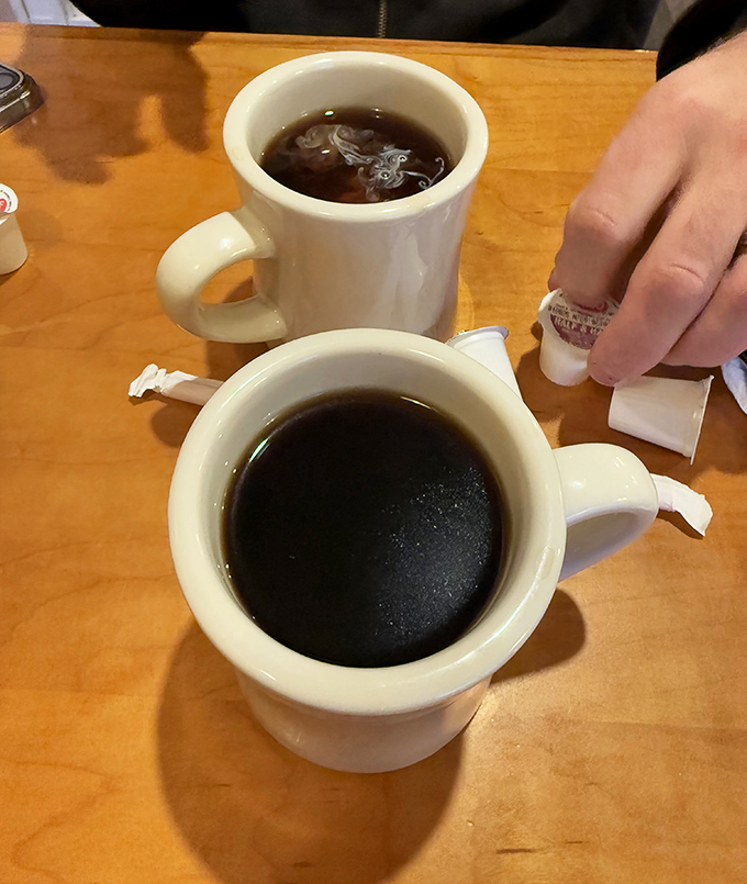 Coffee at diners isn't just a beverage, it's a ritual. These sturdy mugs have witnessed countless conversations, refills, and "just one more cup" promises.