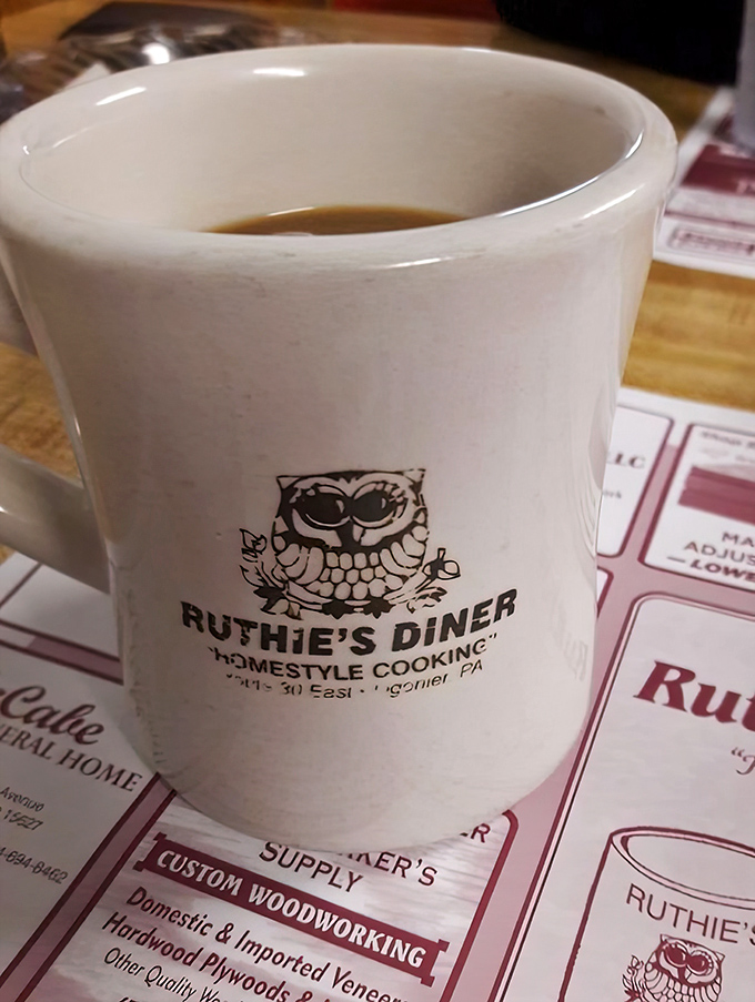 The official mug of morning salvation, emblazoned with Ruthie's owl logo&mdash;because wisdom comes after coffee, never before.