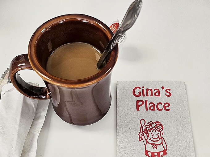 That brown ceramic mug isn't just holding coffee&mdash;it's cradling liquid motivation, served with the kind of napkin that tells you you're among friends.