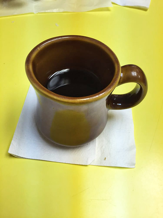 That sturdy brown mug isn't just holding coffee; it's holding the perfect companion for your donut adventure&mdash;simple, honest, and wonderfully old-school.