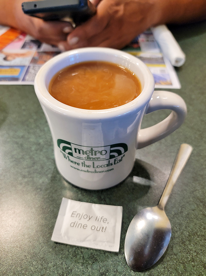 Coffee served with philosophy&mdash;"Enjoy life, dine out!" The mug practically whispers, "Take another sip and order those pancakes you're thinking about."
