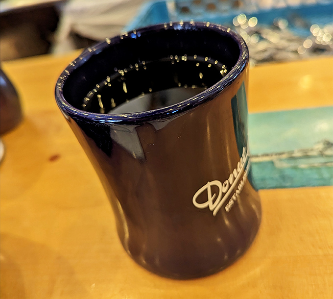 That navy blue mug isn't just holding coffee&mdash;it's holding the motivation you need to face the day. Morning salvation in ceramic form.