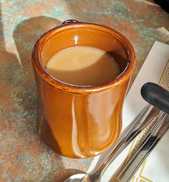 The humble coffee mug&mdash;steady companion to countless conversations and contemplations. In diners like this, refills come with knowing nods, not pretentious pours.