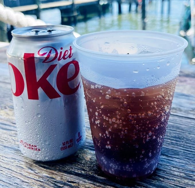 Even a simple soda tastes better with this view. Waterfront dining where every table feels like the captain's table.