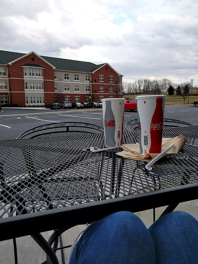 Even the outdoor dining experience feels special here. Those Coke cups aren't just containers; they're companions to pizza perfection.