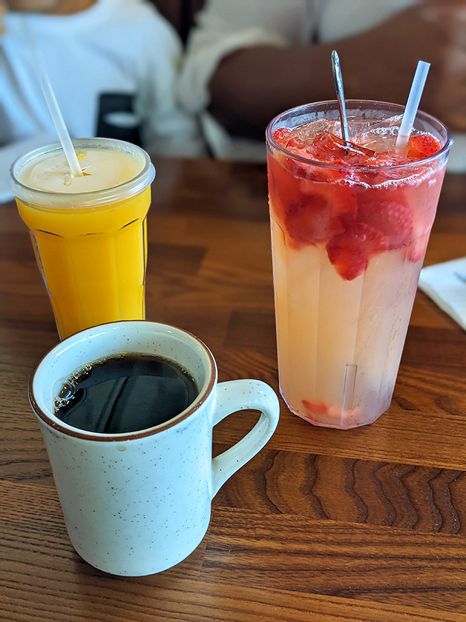 Morning fuel options: robust coffee in a handmade mug, fresh-squeezed orange juice, or a berry-infused refresher that tastes like summer.