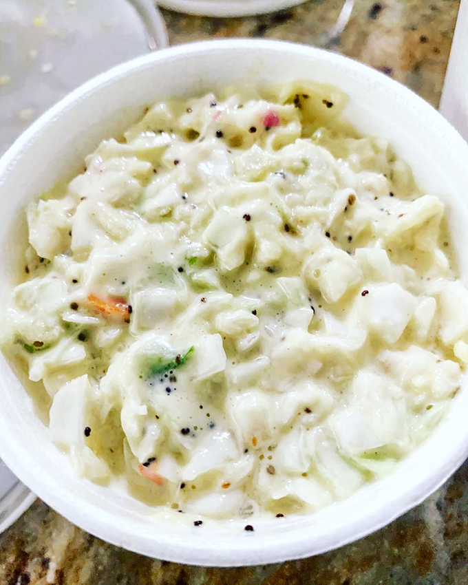 The coleslaw provides welcome crunch and acidity, refreshing the palate between bites of smoky meat like a well-timed palate cleanser.