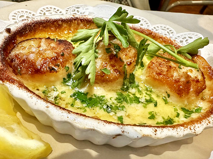Scallops nestled in their shell like pearls in an ocean treasure chest, golden-brown and ready for their close-up.