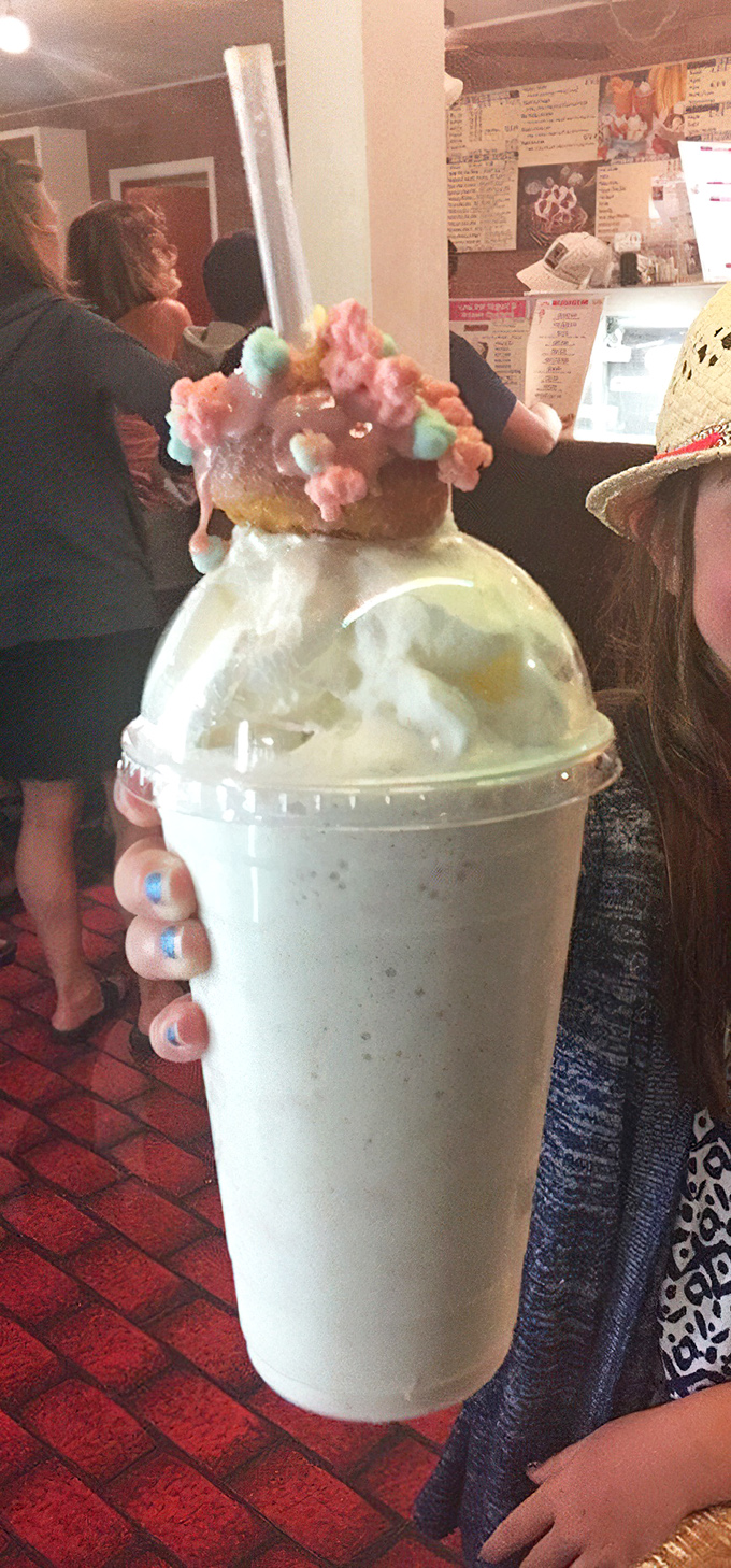 The Cotton Candy Shake defies gravity and good sense, topped with what appears to be an entire carnival's worth of sugary delight.
