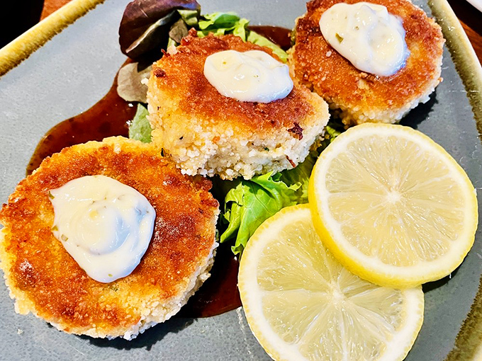 Crab cakes that actually taste like crab &ndash; revolutionary concept, perfectly executed with golden-brown confidence.