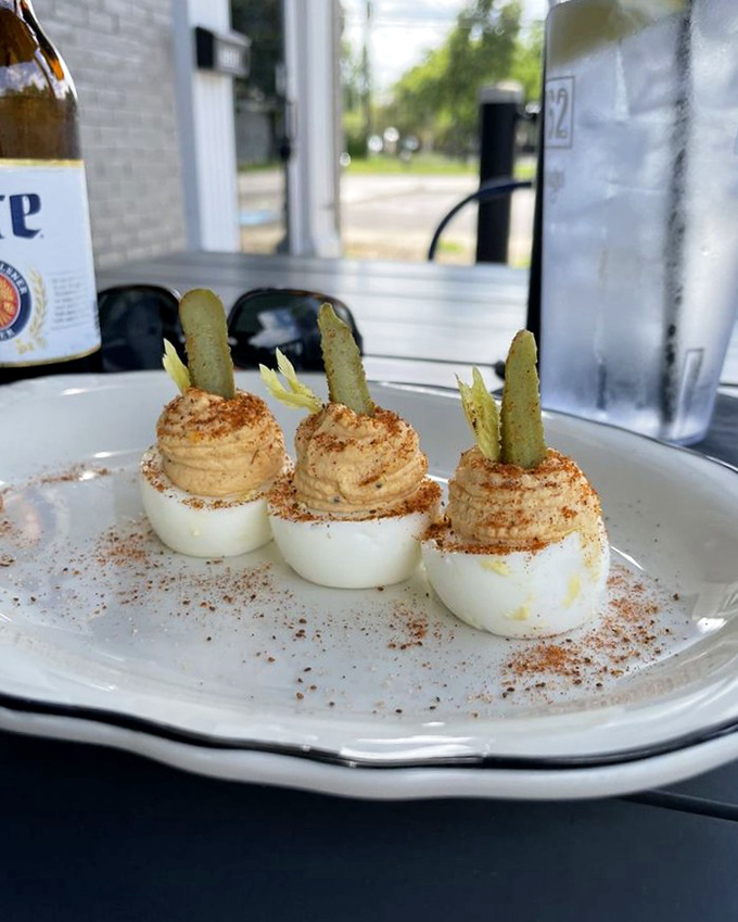 Deviled eggs elevated to art form. Those pickle spears standing at attention like tiny soldiers guarding treasures of whipped yolky goodness.