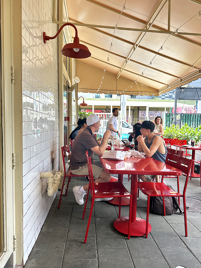 The outdoor seating area: where strangers become friends united by the universal language of "mmm" and "have you tried the Louie sauce?"