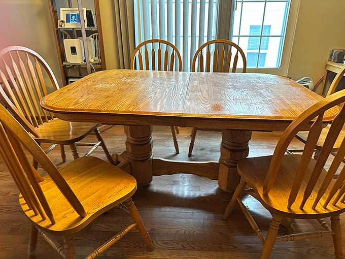 Solid oak dining set with Windsor chairs&mdash;the kind of craftsmanship that's outlasted three presidential administrations and countless family dinners.