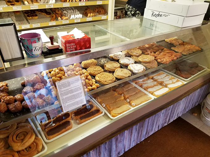 The display case at Donut World is essentially the Louvre of fried dough. Each shelf a gallery, each donut a masterpiece, no admission fee required.