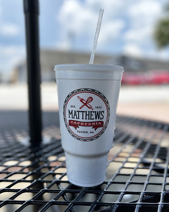 Sweet tea served in a cup bearing the Matthews logo&mdash;liquid Southern hospitality that'll keep you cool while simultaneously giving you a sugar rush.