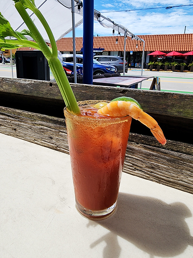 A Bloody Mary with a shrimp garnish – because sometimes your cocktail should double as an appetizer while you watch the world go by.