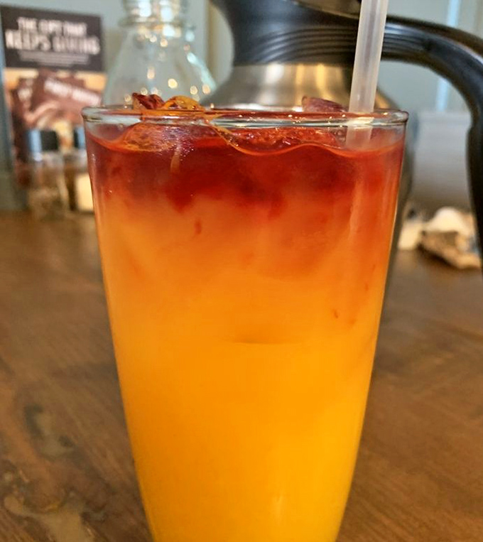Sunrise in a glass! This vibrant orange juice gradient looks like it was mixed by Mother Nature herself after taking an art class.