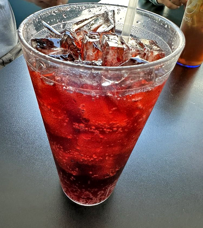 That cherry-red soda isn't just a drink&mdash;it's summer in a glass, childhood memories with ice, and the perfect companion to anything fried.